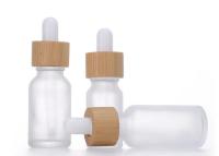 China Empty Essential Oil Bamboo Cap 30ml Glass Dropper Bottle Transparent Frosted for sale