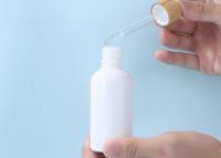 China Opal White Porcelain Ceramic 30ml 50ml Glass Dropper Bottle With Bamboo Cap for sale