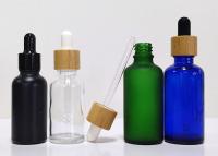 China 100 Ml Essential Oil Black Glass Dropper Bottle With Bamboo Lids for sale