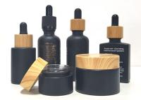 China 100 Ml Essential Oil Black Glass Dropper Bottle With Bamboo Lids for sale