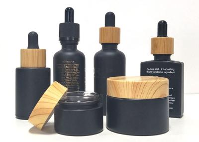 China 100 Ml Essential Oil Black Glass Dropper Bottle With Bamboo Lids for sale