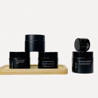 China 50g 1oz 2oz 100g Matte Black Thick Bottom Glass Cosmetic Cream Jar for sale