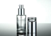 China 1 Oz Transparent Facial Serum Oil Empty Glass Lotion Bottle With Silver Pump Caps for sale