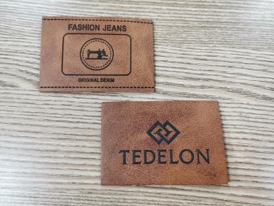 China Embossed Logo PU Leather Patches Custom Color Sew On Clothing for sale