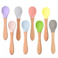 China Wooden Handle Infant Feeding Spoon BPA Free Food Grade Soft Silicone Baby Spoon for sale
