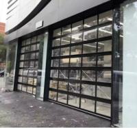 China Residential Aluminum Sectional Door Transparent Glass Panel Adjusted Height 550mm for sale