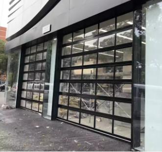 China Residential Aluminum Sectional Door Transparent Glass Panel Adjusted Height 550mm for sale