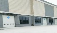 China Large Industrial Workshop Sectional Overhead Door Flat Or Contoured Panel Design 50mm-80mm Thickness Insulated Sectional Garage Door for sale