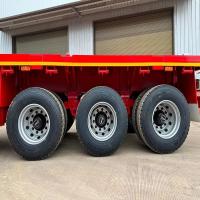 China 12r22.5 Tire 3 Axles 4 Axles Container Semi Trailer 40hq Flatbed Cargo Semi Trailer for sale