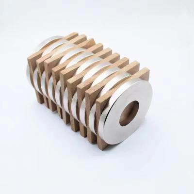 China Disc Magnet with Hole N35 N45 Magnet for Magnetization Direction Through Thickness for sale