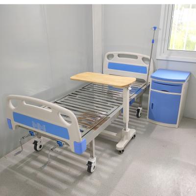 China 2-Function Stainless Steel Manual Hospital Bed With IV Pole Bedside Table & Cabinet for sale