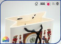 China 190gsm Solid Colored Art Paper Gift Bag With Ribbon Handle For Christmas Treat Bags for sale