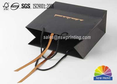 China Ribbon Decoration Luxury Black Gift Paper Bags With Logo Hot Gold Stamping for sale