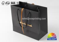 China Ribbon Decoration Luxury Black Gift Paper Bags With Logo Hot Gold Stamping for sale