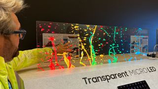 The Samsung Micro LED a CES with a person's hand behind it, to show the transparency