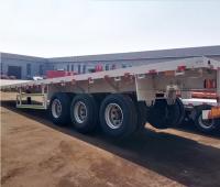 China Truck Trailer Flatbed Semi Trailer With 30-60 Tons Loading Capacity And 1 Tool Box Big Chamber for sale