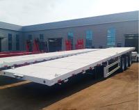 China Truck Trailer Flatbed Semi Trailer With 30-60 Tons Loading Capacity And 1 Tool Box Big Chamber for sale