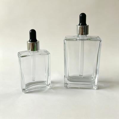 China Rectangle Clear Glass Dropper Bottles For 50ml 100ml Essential Oil for sale