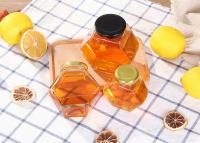 China 250ml-750ml Glass Honey Jars With Lids , Hexagon Glass Jars Clear Color for sale