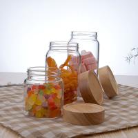 China High Borosilicate Empty Glass Jars Air Tight Storage Jars Containers With Wood Lid for sale