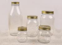 China Clear Carved Glass Storage Jars With Gold Color Screw Lid Round Shape for sale