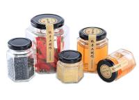 China Clear Hexagon Honey Jars Hexagon Glass Jar With Black Lids 100ml 180ml for sale