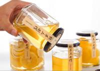 China Clear Hexagon Honey Jars Hexagon Glass Jar With Black Lids 100ml 180ml for sale