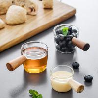 China Home Cooking Delicate Wooden Handle Glass Measuring Spoon for sale