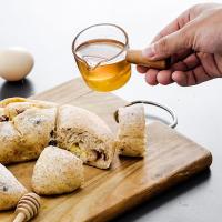 China Home Cooking Delicate Wooden Handle Glass Measuring Spoon for sale