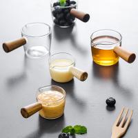 China Home Cooking Delicate Wooden Handle Glass Measuring Spoon for sale