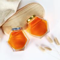 China Custom 230ml 350ml hexagon honey glass jar with Metal Lids and labels for sale