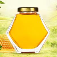 China Custom 230ml 350ml hexagon honey glass jar with Metal Lids and labels for sale