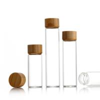 China Hot Sale Mini Bamboo Lid Glass Packaging Bottle Small Borosilicate Glass Bottle for sale