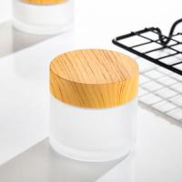 China Frosted Skincare Cosmetic Glass Bottles 15g 30g Glass Cream Jar With Bamboo Lid for sale