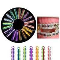 China Bicolor Latex Free Orthodontic Elastic Ligature Ties with 20 Sticks per Pack for Secure Archwire Engagement for sale