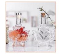 China Custom Color Industrial Glass Beverage Bottle with Maple Leaf Shape 50ml 100ml 250ml for sale