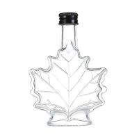 China Custom Color Industrial Glass Beverage Bottle with Maple Leaf Shape 50ml 100ml 250ml for sale