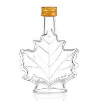 China Custom Color Industrial Glass Beverage Bottle with Maple Leaf Shape 50ml 100ml 250ml for sale