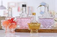China Custom Color Industrial Glass Beverage Bottle with Maple Leaf Shape 50ml 100ml 250ml for sale