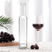 China 200ml 375ml 500ml 750ml 1000ml round glass liquor bottle with cork lid and custom design for sale