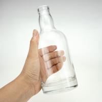 China Customized Logo Shape Closures 750ml Empty Unique Glass Bottle For Liquor With Cap for sale