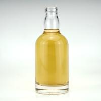 China Customized Logo Shape Closures 750ml Empty Unique Glass Bottle For Liquor With Cap for sale