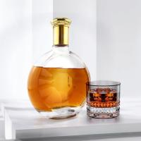 China Custom 700Ml Round Flint Glass Liquor Wine Whisky Vodka Tequila Bottle With Cork Lid for sale