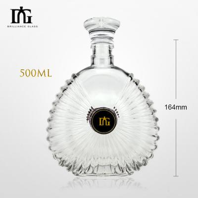 China 500ml Embossed Round Glass Bottle for Liquor Brandy Vodka Whisky Gin Rum Custom Design for sale