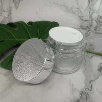 China MSDS Clear 100g Glass Cream Jar With Shiny Silver Cap White Lid Mask Mud for sale