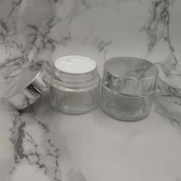 China MSDS Clear 100g Glass Cream Jar With Shiny Silver Cap White Lid Mask Mud for sale