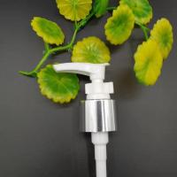 China Small Dosage 0.7CC 24 / 410 Lotion Pump With Clip Silver Shine Aluminum Closure for sale