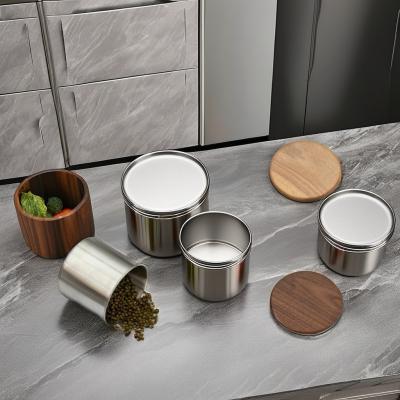 China 8*7.5cm Carved Stainless Steel Coffee Canister with Modern Wooden Lid and Vacuum Seal for sale