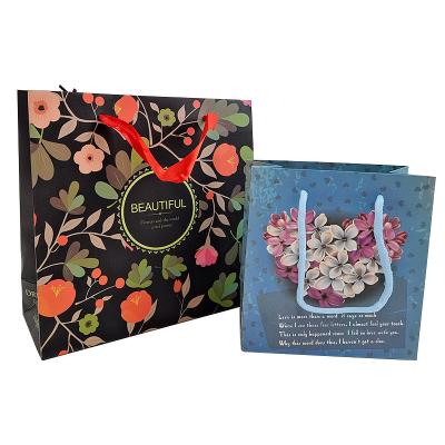 China Custom Logo Printing Reusable Kraft Paper Packaging With Handle Kraft Paper Packaging Gift Bag for sale