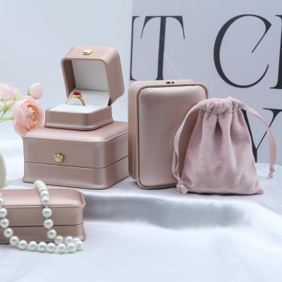 China Pink PU Leatherette Jewelry Case Wedding Ring Box With Velvet Lining Elegant Packaging for sale
